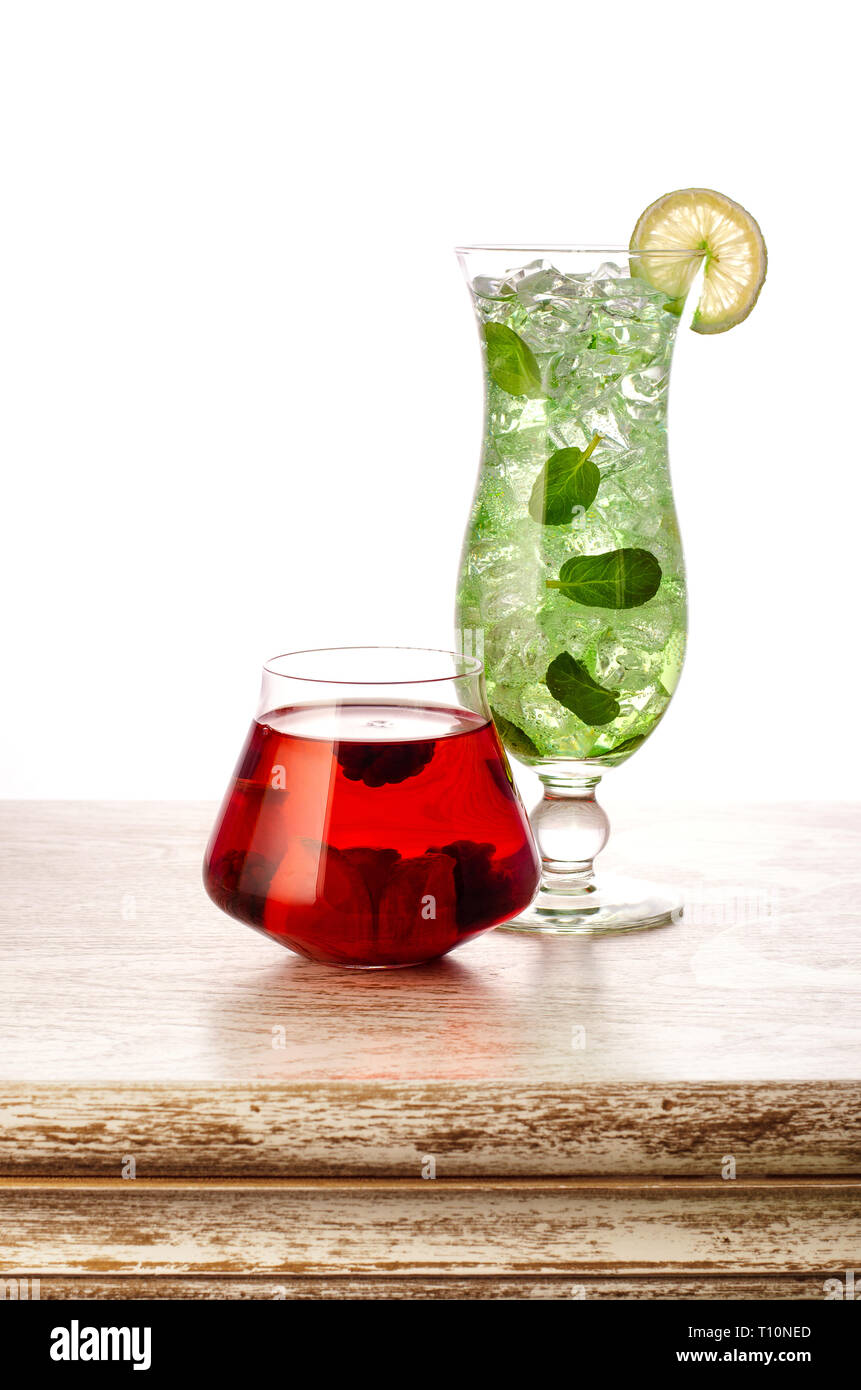 two cocktails on the wooden table isolated on white background ...