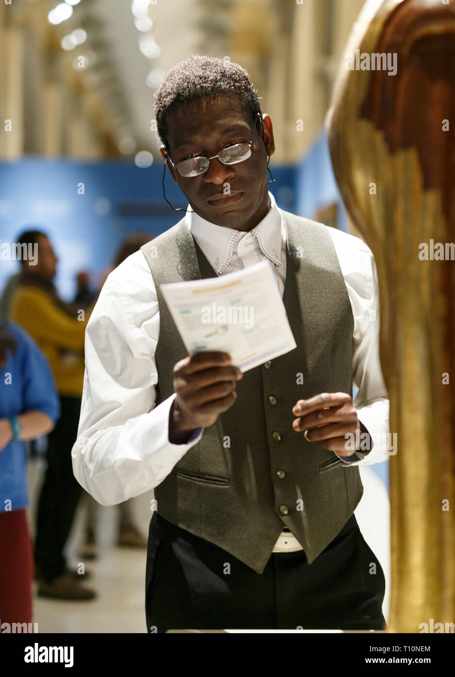 Mature african man reading brochure about exhibits on exposition of ...