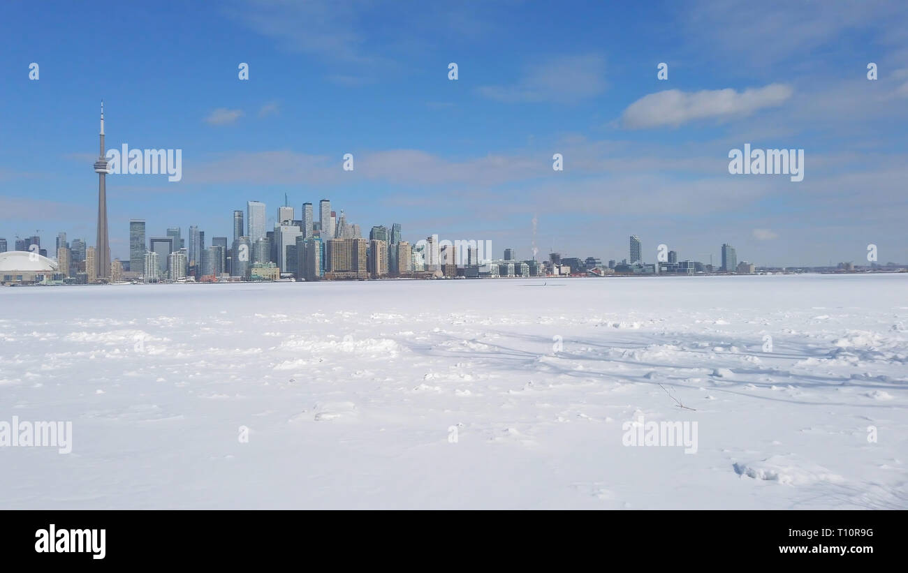 View of Toronto city skyline form Toronto Islands across frozen lake ...