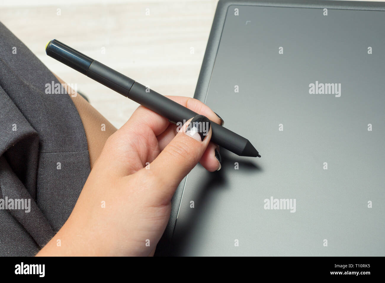 Hand of graphic designer working with stilus and tablet Stock Photo - Alamy