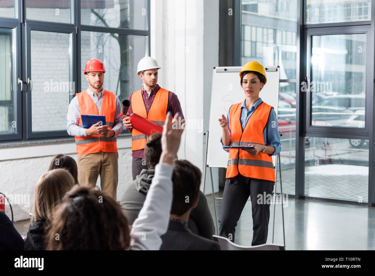 selective focus of firemen in helmets standing near attractive ...