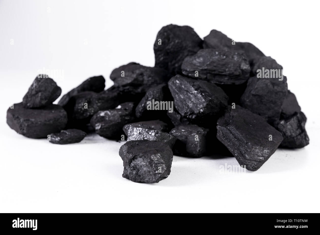 Pile of coal isolated on white Stock Photo - Alamy