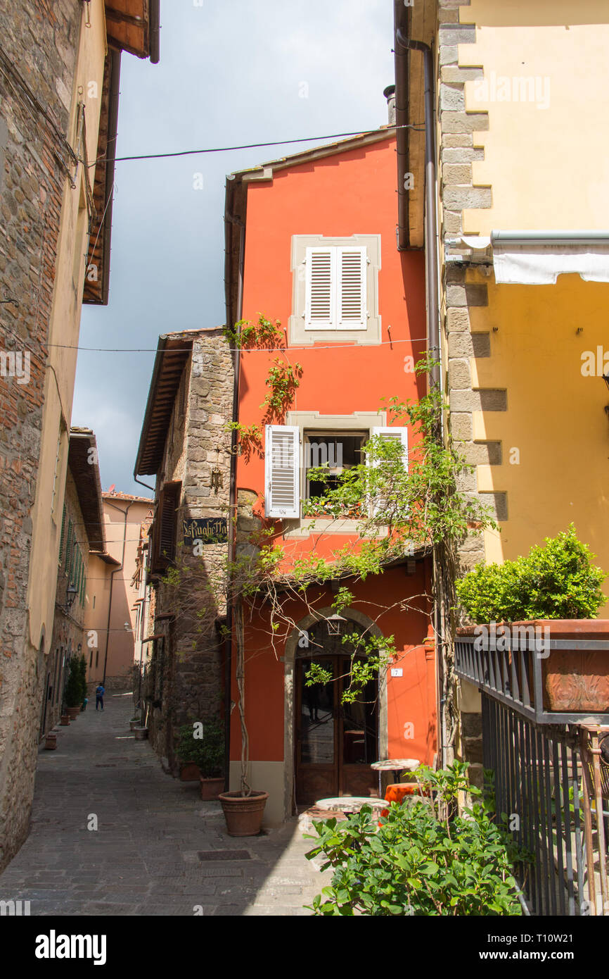 The view of a narrow street and typical Italian house facade fragment ...