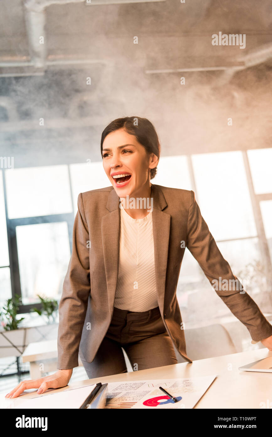 attractive scared woman screaming in office with smoke Stock Photo - Alamy