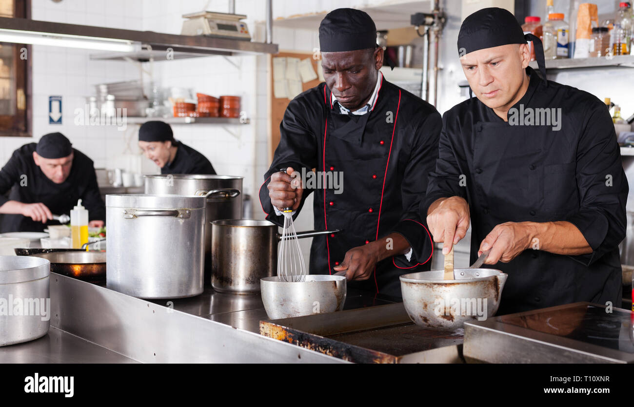 Professional male chef in kitchen of restaurant Stock Photo - Alamy