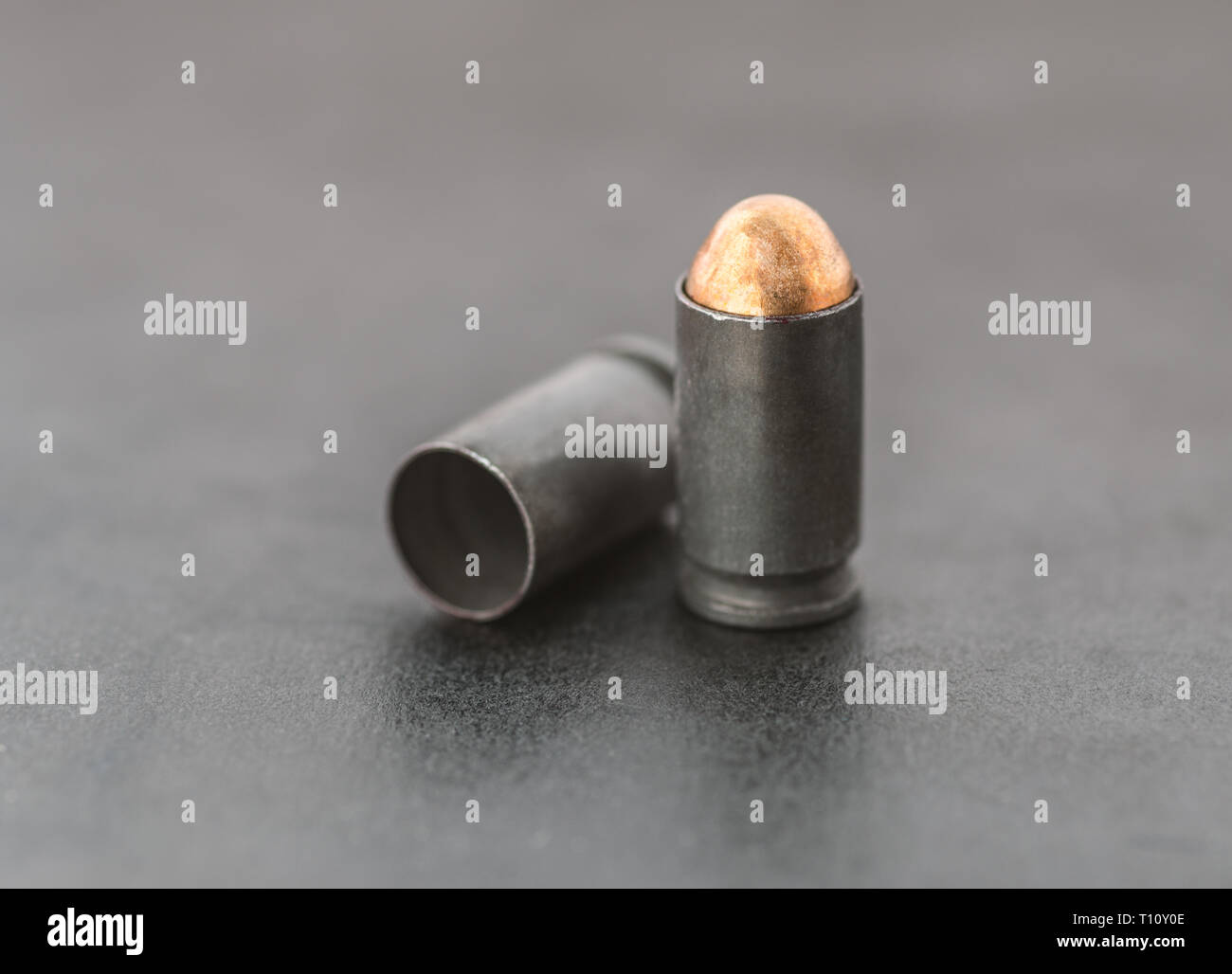 Two bullets on dark background Stock Photo - Alamy