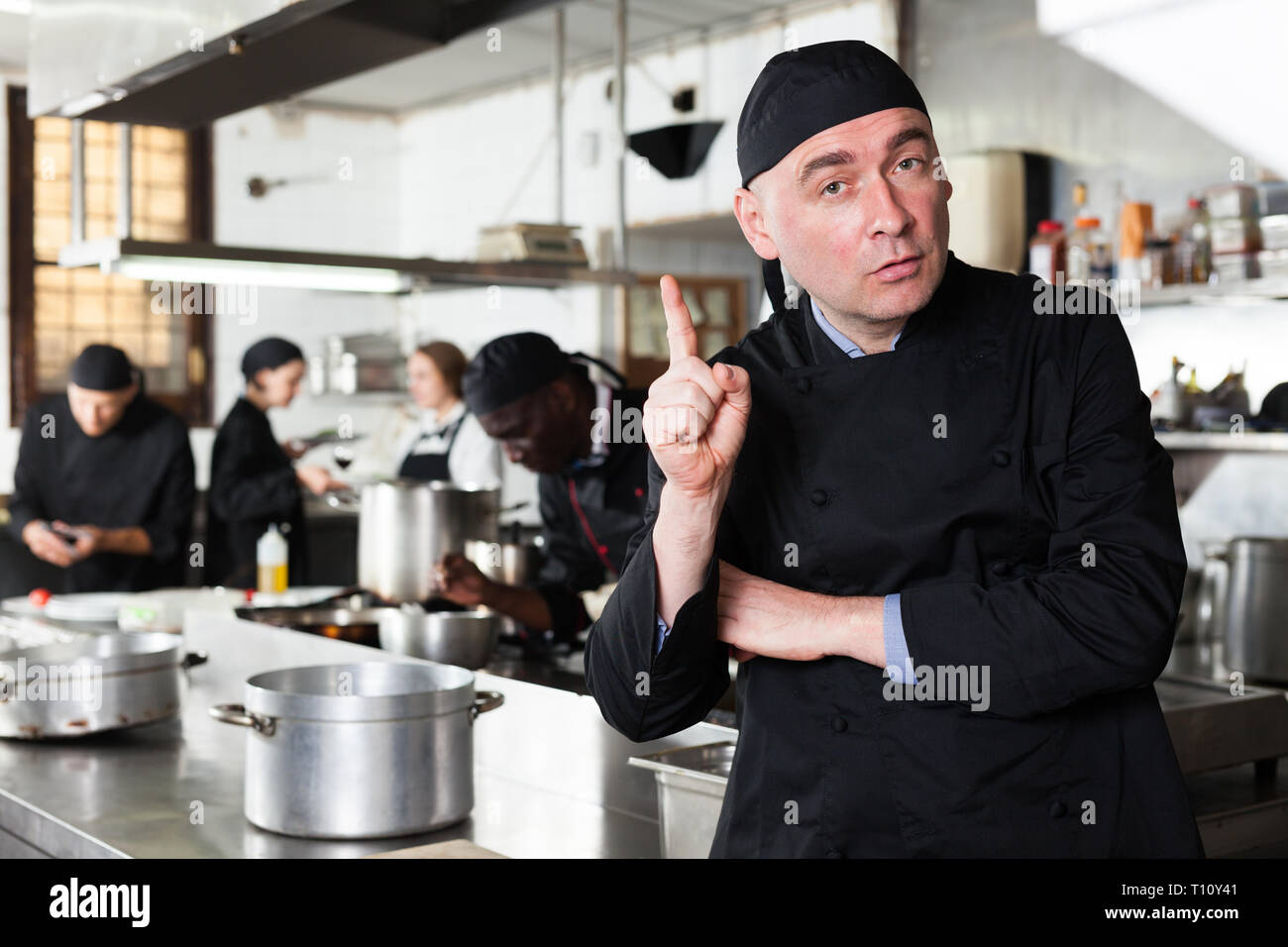 Professional male chef in kitchen of restaurant Stock Photo - Alamy