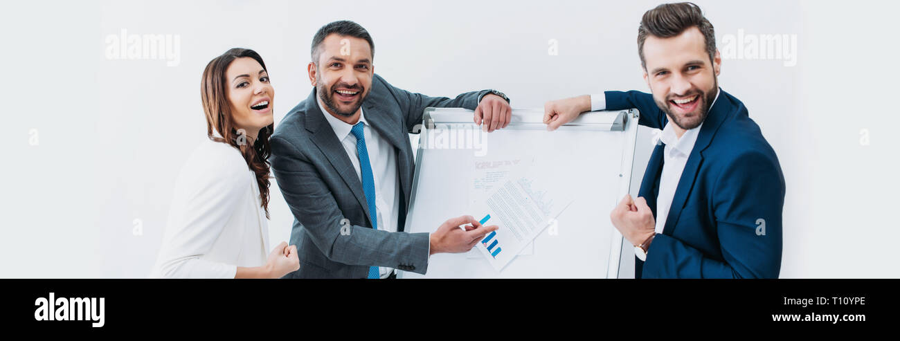 colleagues standing near stand with document and smiling isolated on ...
