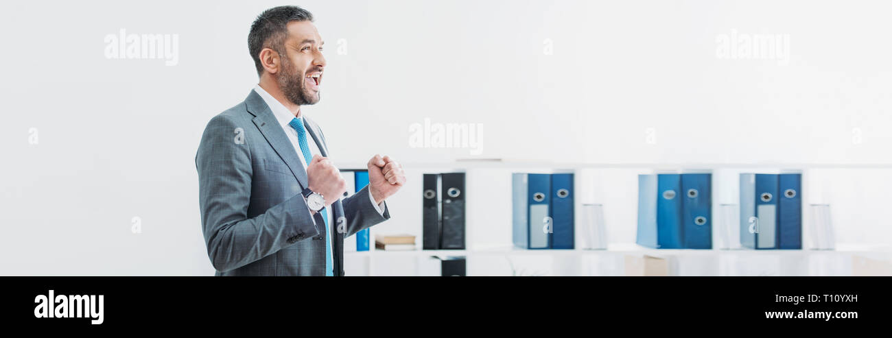handsome businessman standing and showing yes gesture in office Stock ...