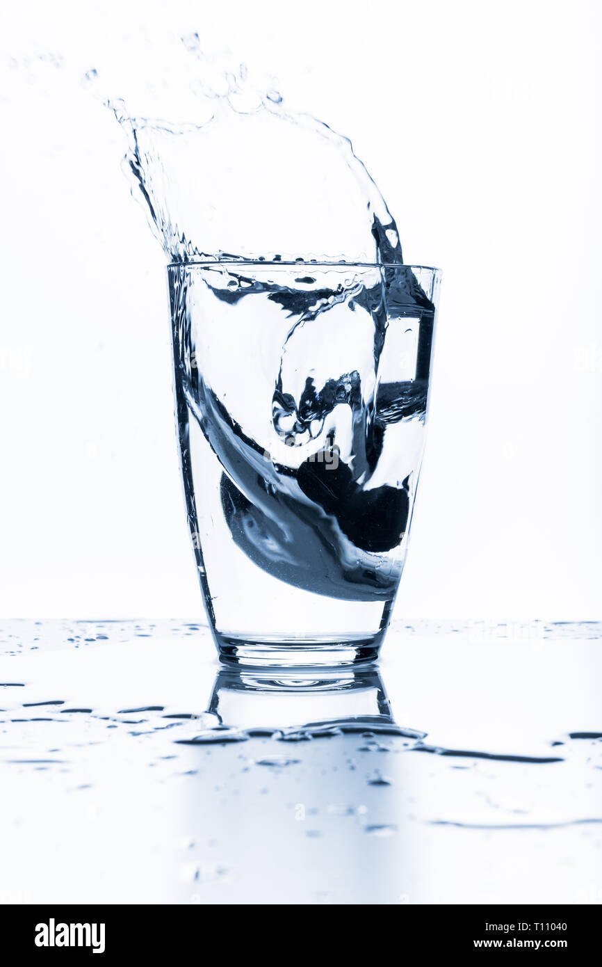 water splashing from glass isolated on white background Stock Photo - Alamy