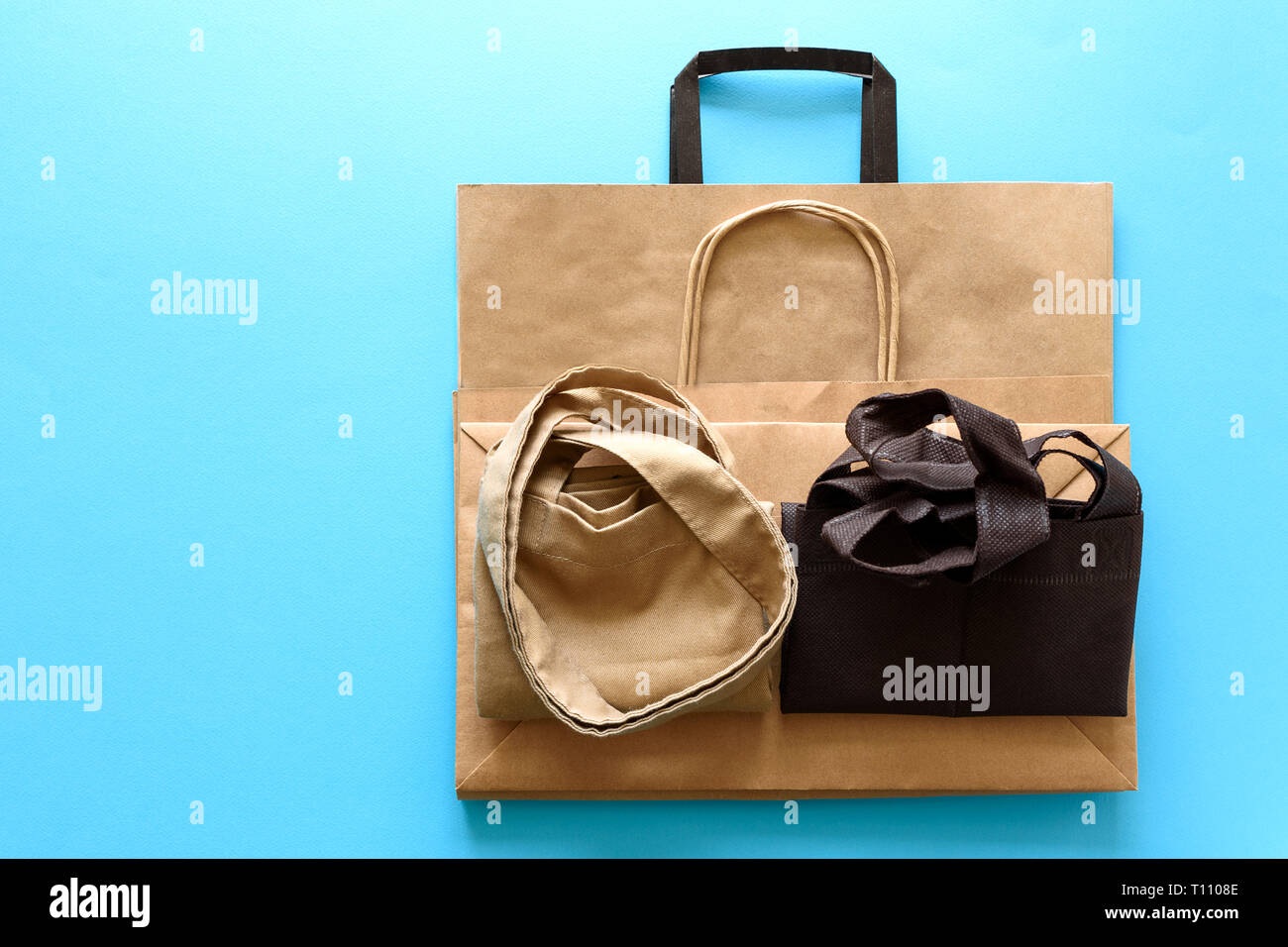 Brown empty kraft paper and linen case bags on blue background. Top ...