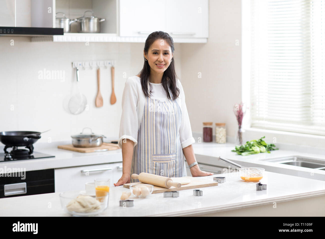 Happy mature woman baking hi-res stock photography and images - Alamy