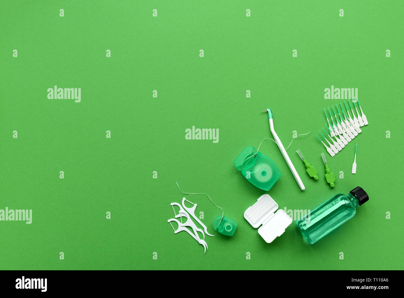 Different tools for dental care on green background. Toothbrush ...