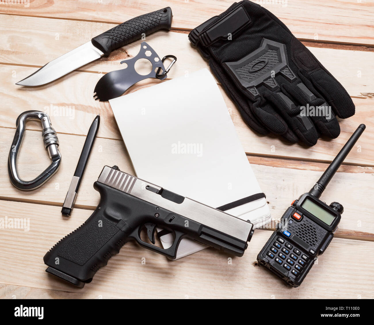 Assault rifle, gun, knife with sheath, compass and notebook with pen on ...