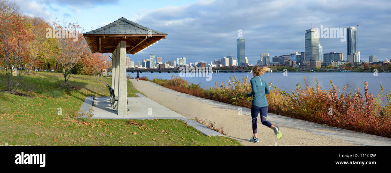 Boston pano in the fall. People walking and running on Charles River ...