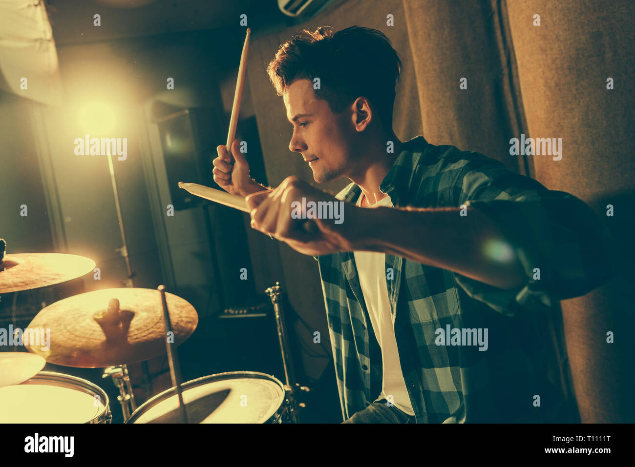 handsome drummer holding drum sticks and playing drums Stock Photo - Alamy