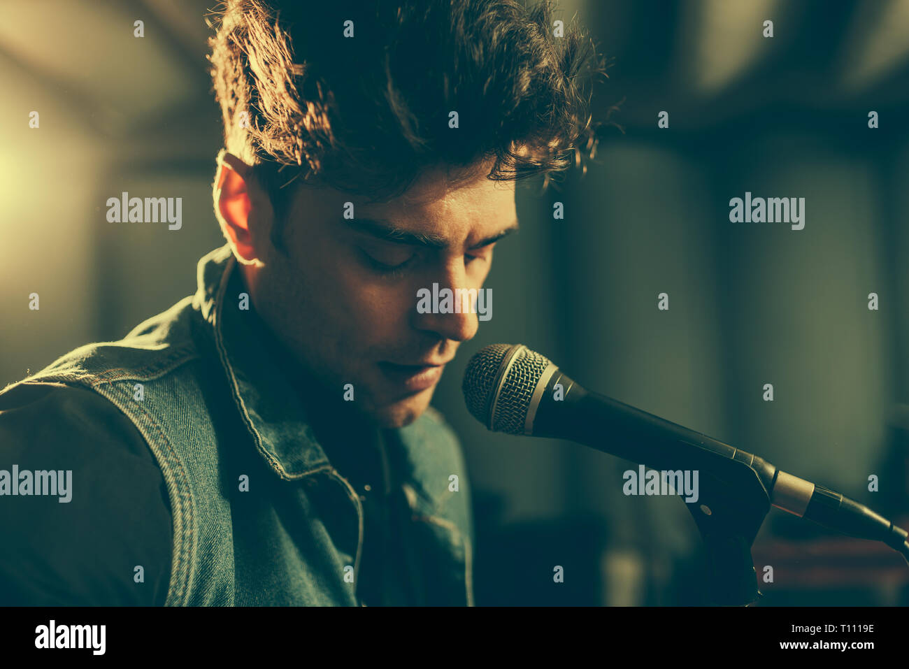 close up of good-looking musician singing in microphone Stock Photo - Alamy