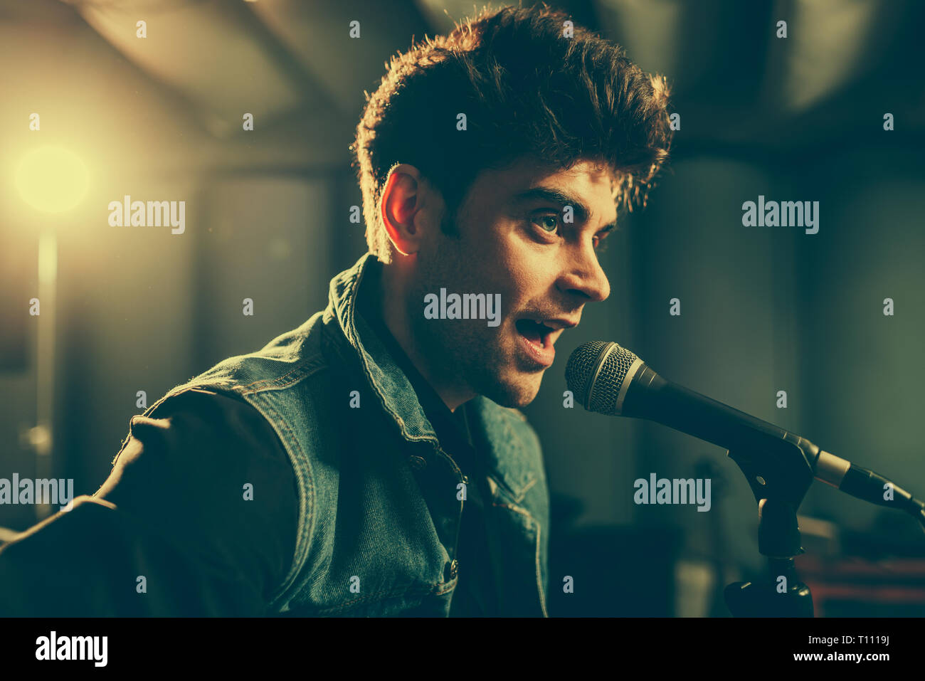 stylish and handsome singer singing in microphone Stock Photo - Alamy