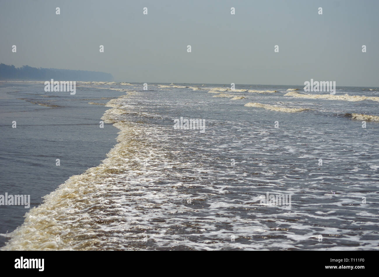 Clean water waves on beach Stock Photo - Alamy