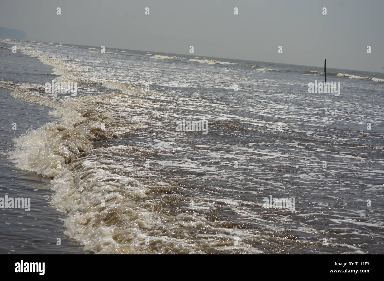 Clean water waves on beach Stock Photo - Alamy