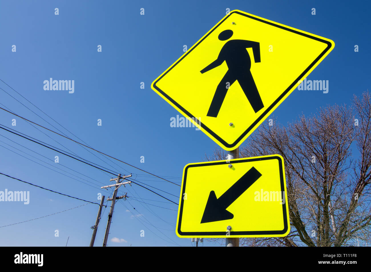 Pedestrian crossing sign in reflective yellow Stock Photo - Alamy