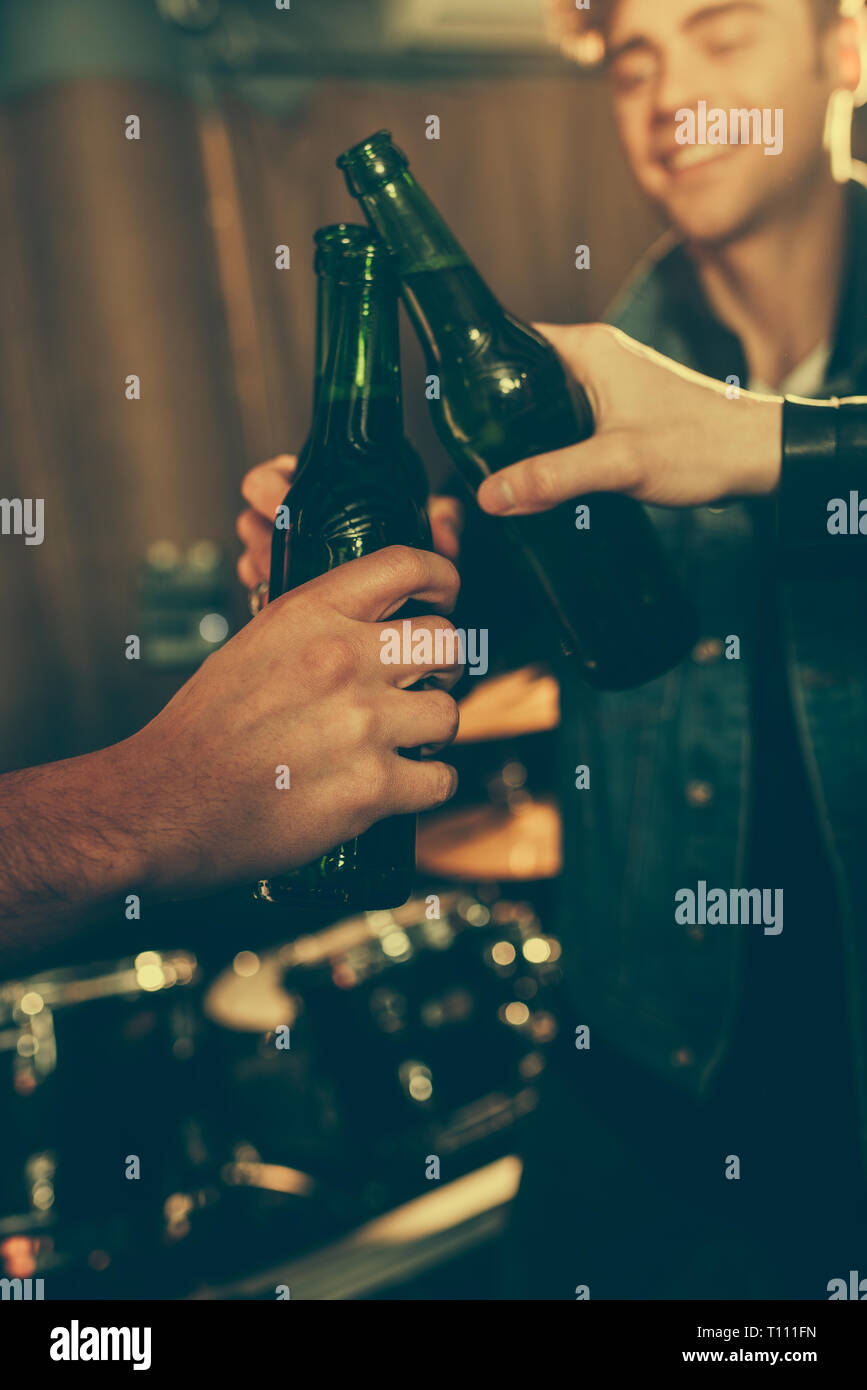 Cheerful people clinking glass bottles hi-res stock photography and ...