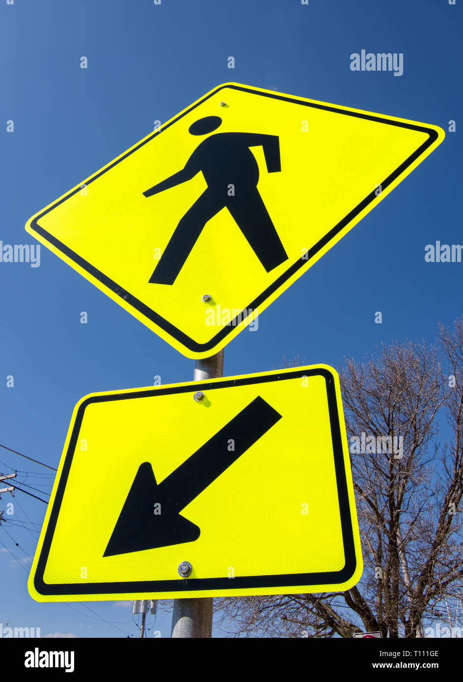 Pedestrian crossing sign in reflective yellow Stock Photo - Alamy