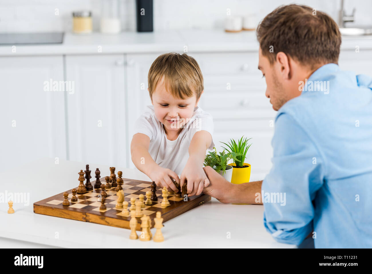 Boy father playing chess table hi-res stock photography and images - Alamy