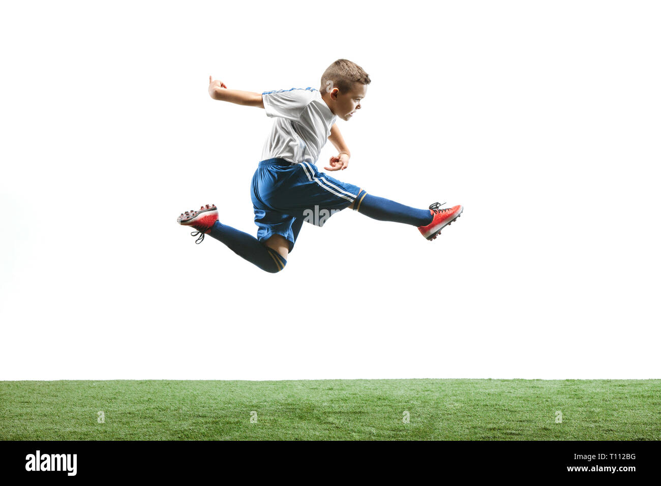 Young boy running and jumping isolated on white studio background ...