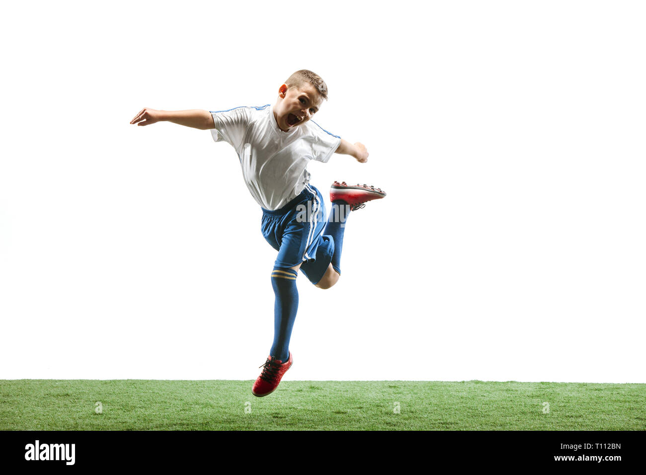 Young boy running and jumping isolated on white studio background ...
