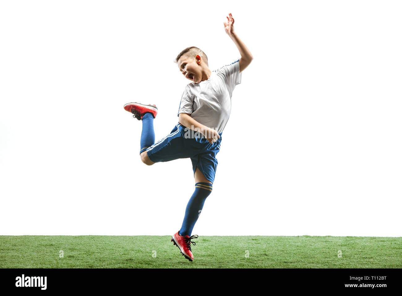 Young boy running and jumping isolated on white studio background ...