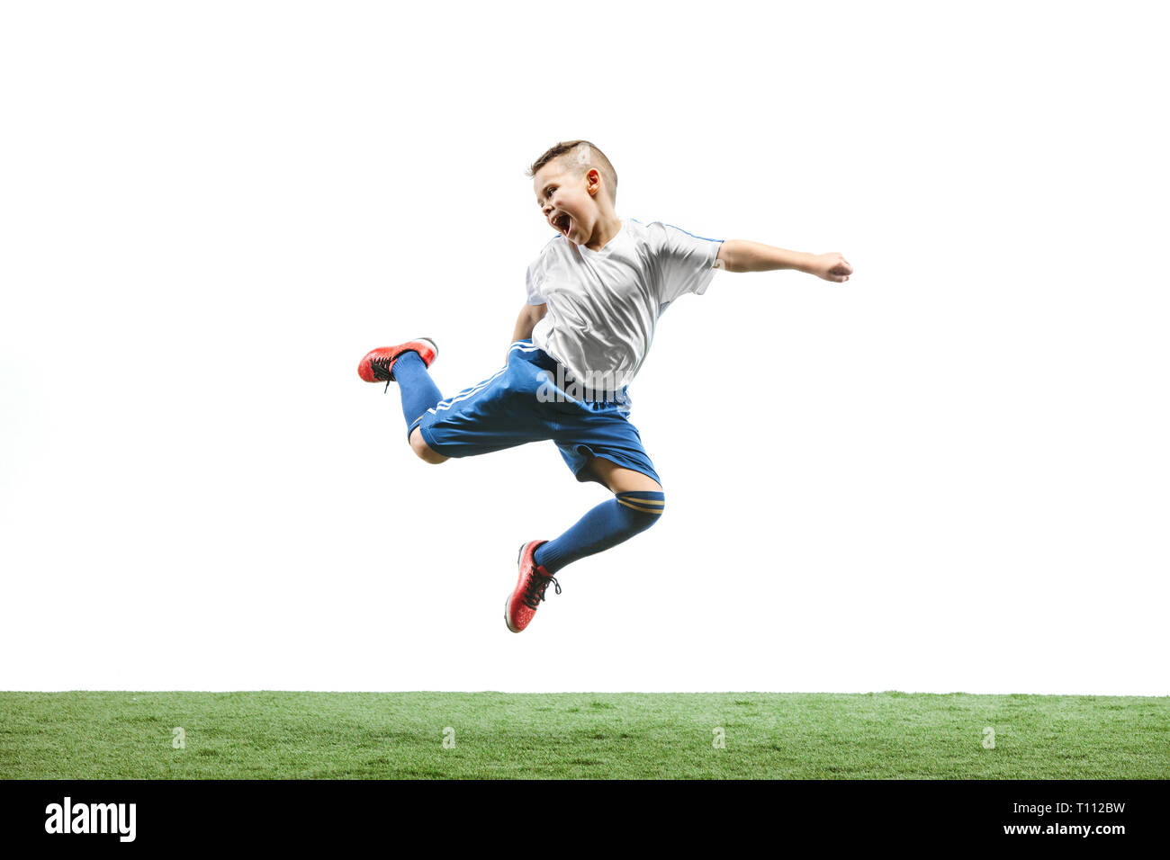 Young boy running and jumping isolated on white studio background ...