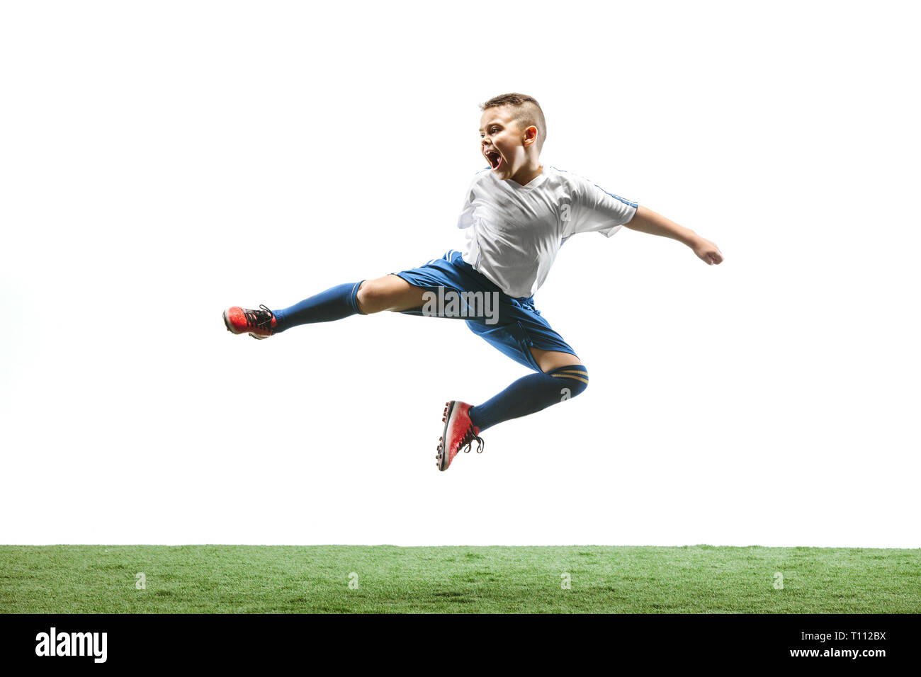 Young boy running and jumping isolated on white studio background ...