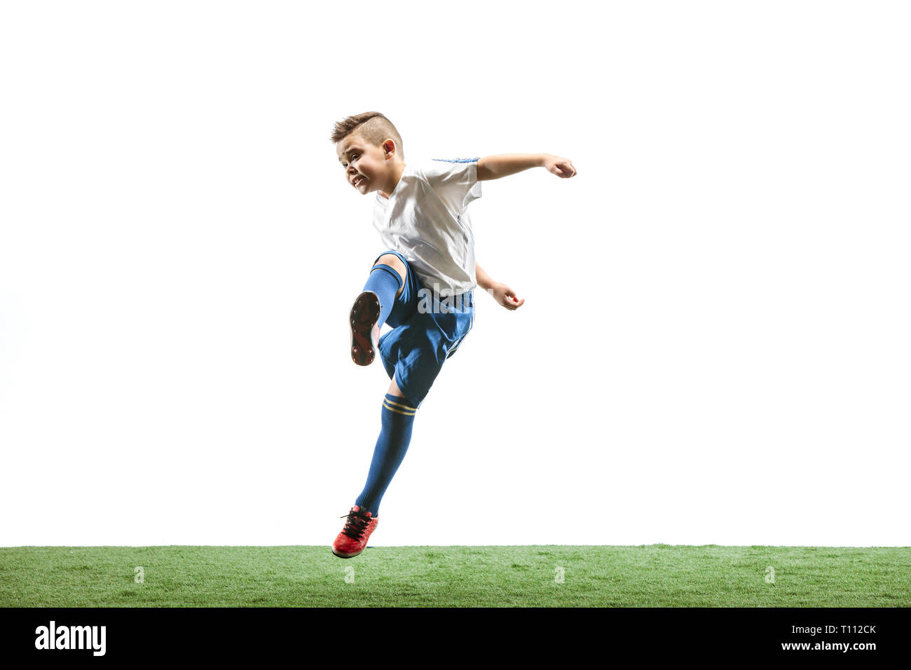 Young boy running and jumping isolated on white studio background ...