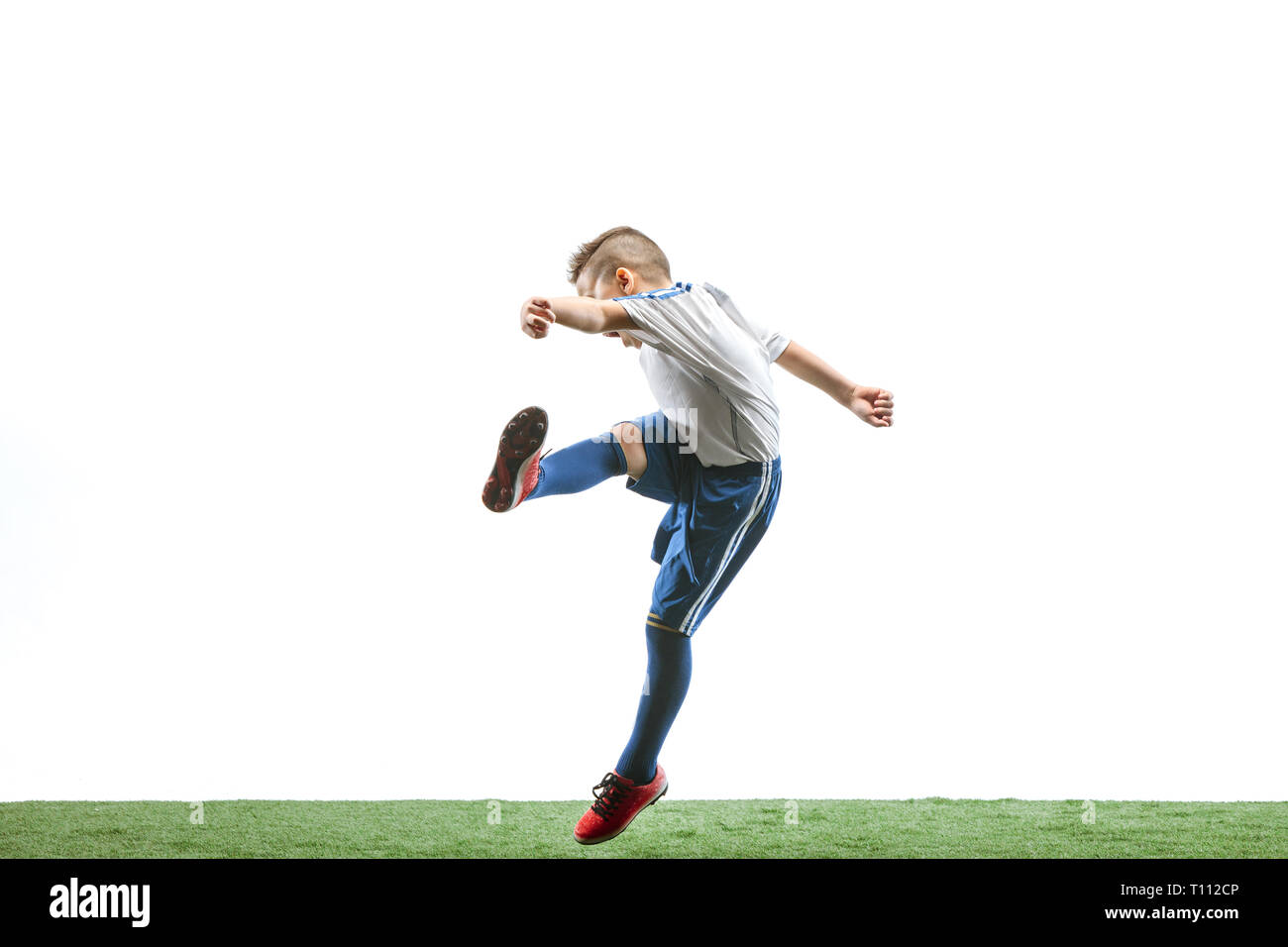Young boy running and jumping isolated on white studio background ...