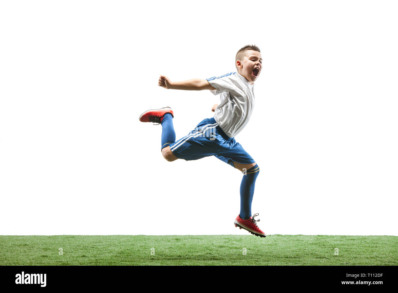 Young boy running and jumping isolated on white studio background ...
