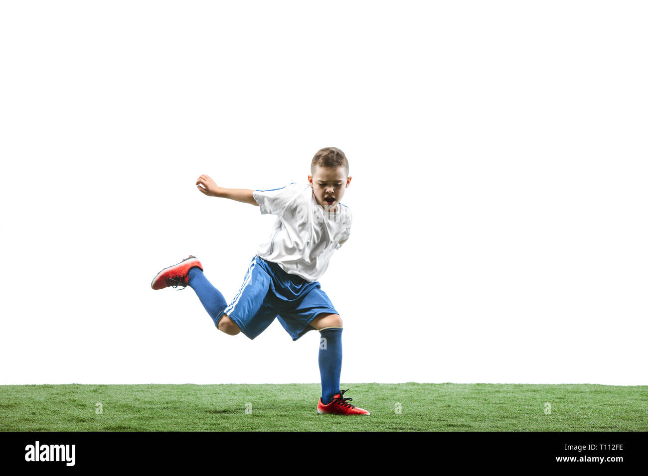 Young boy running and jumping isolated on white studio background ...