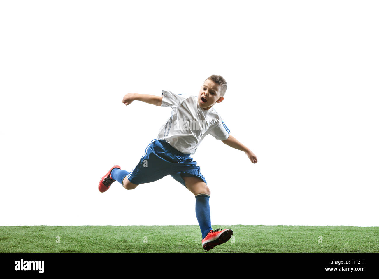 Young boy running and jumping isolated on white studio background ...
