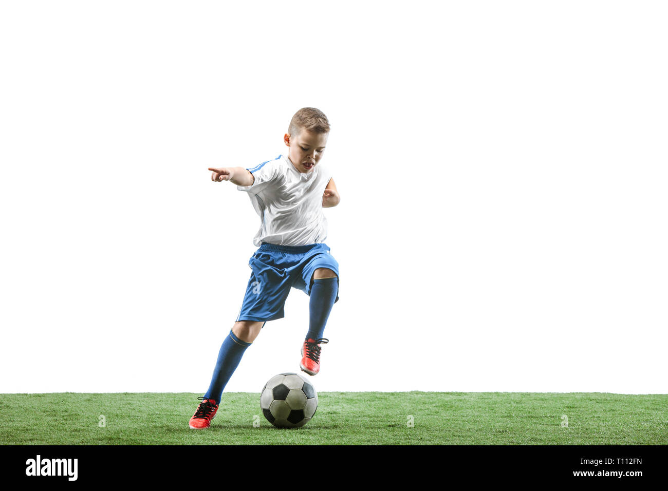 Young boy running and jumping isolated on white studio background ...