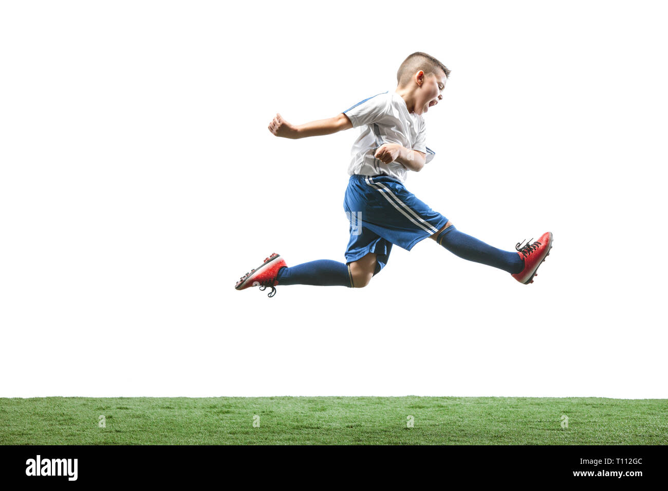 Young boy running and jumping isolated on white studio background ...