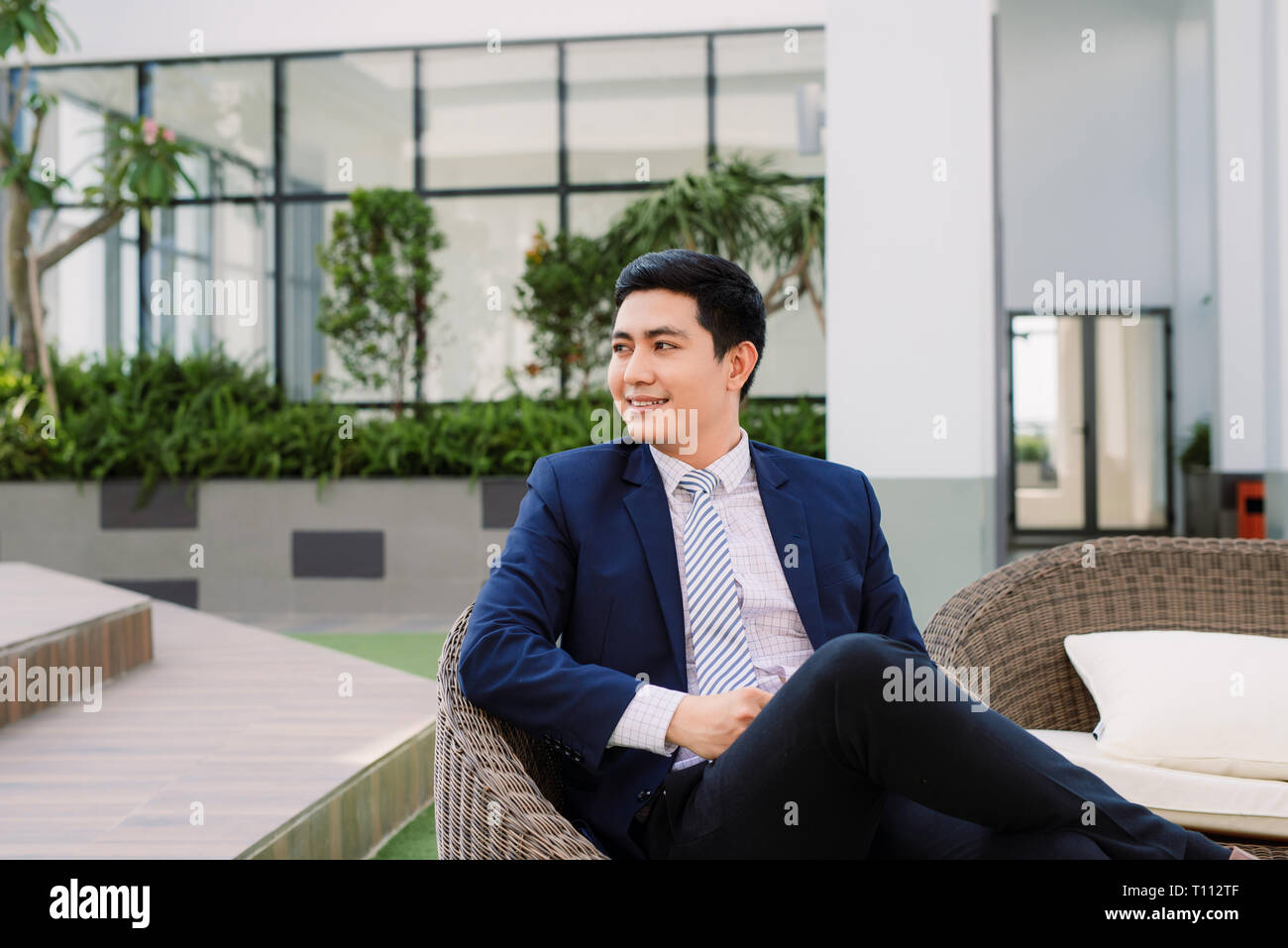Successful intelligent business man relaxing in a restaurant outdoors ...