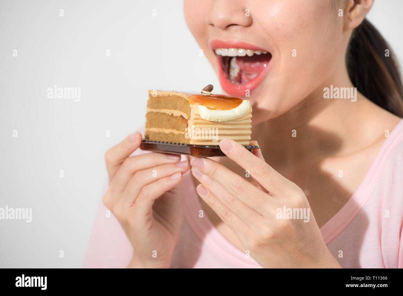 Beautiful smiling asian young woman with a chocolate cake isolated on ...