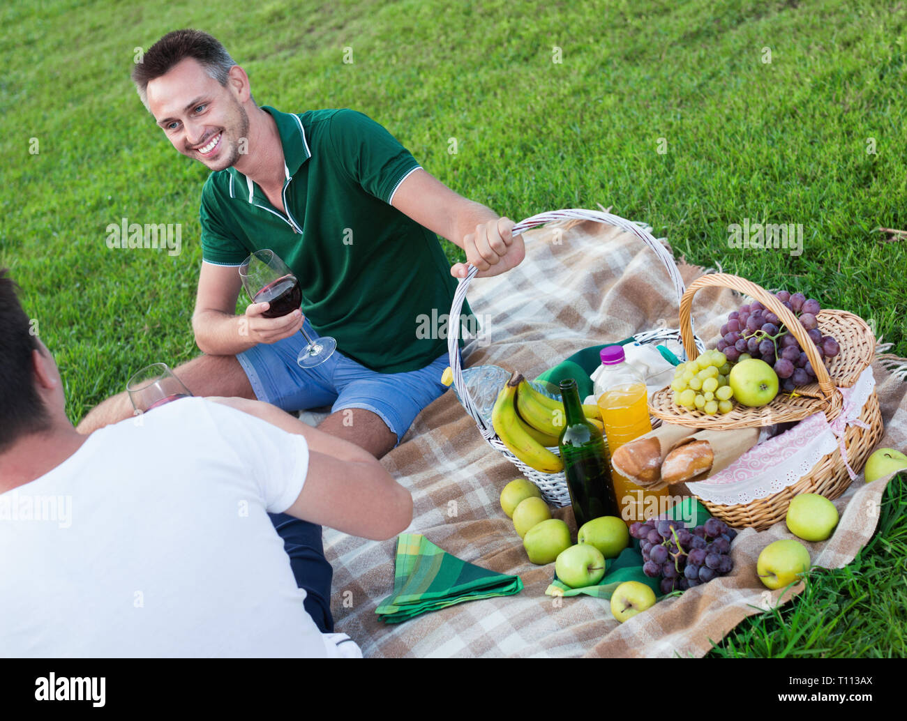 Happy positive smiling man enjoying life on picnic outdoors with his ...