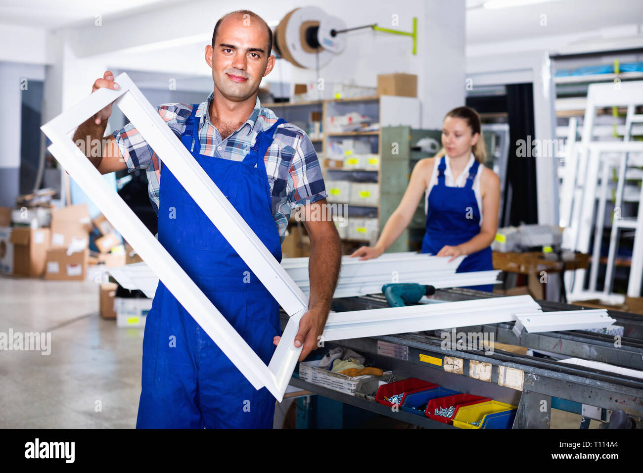 Portrait of experienced cheerful positive smiling male worker with ...