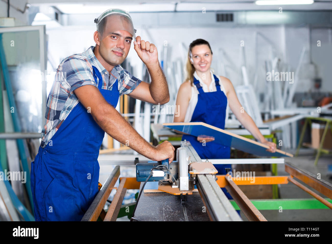 Worker male is ready to work on circular saw in assembly shop with his ...
