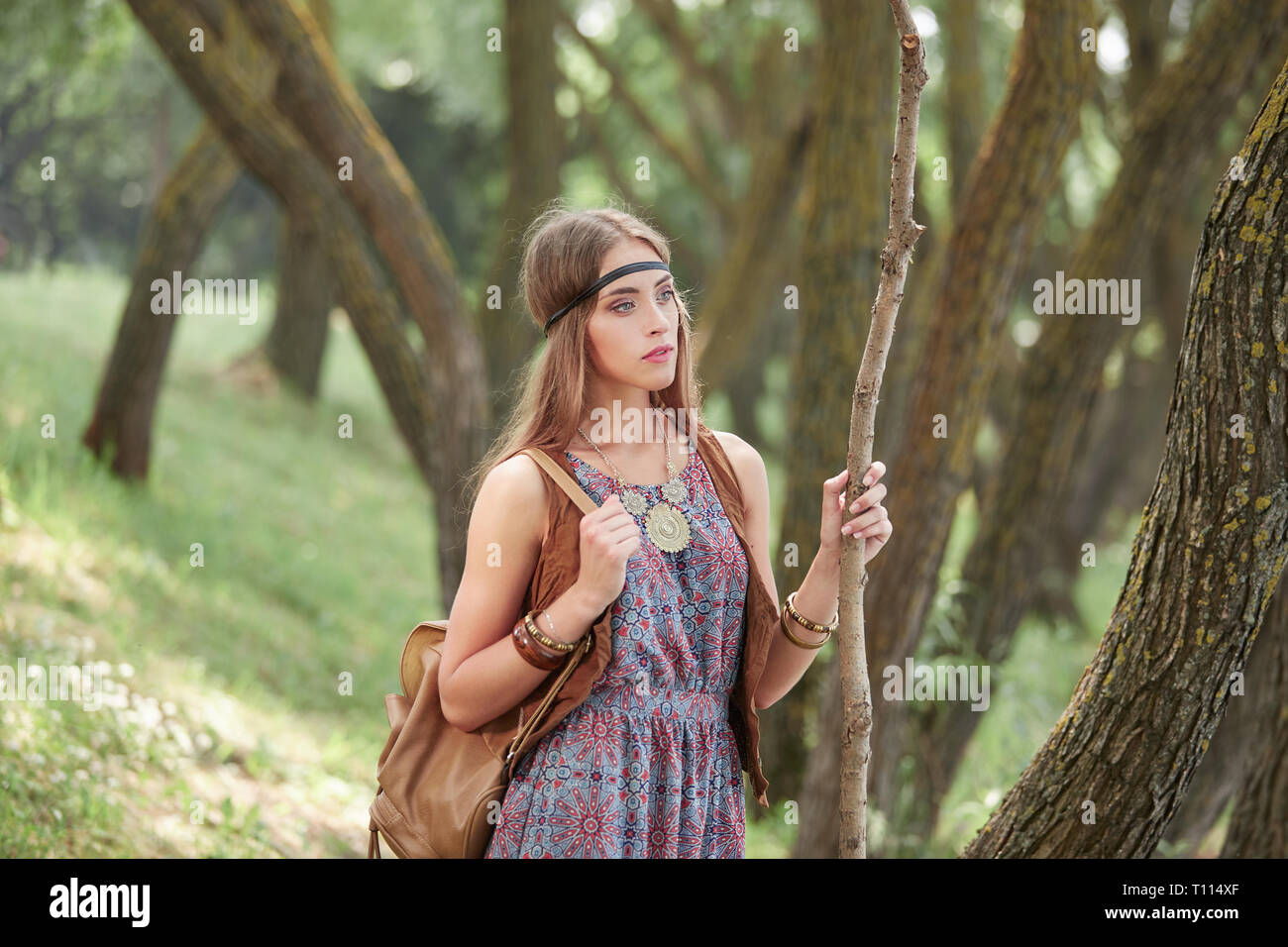 young hippie woman with a bag walking through the woods Stock Photo - Alamy