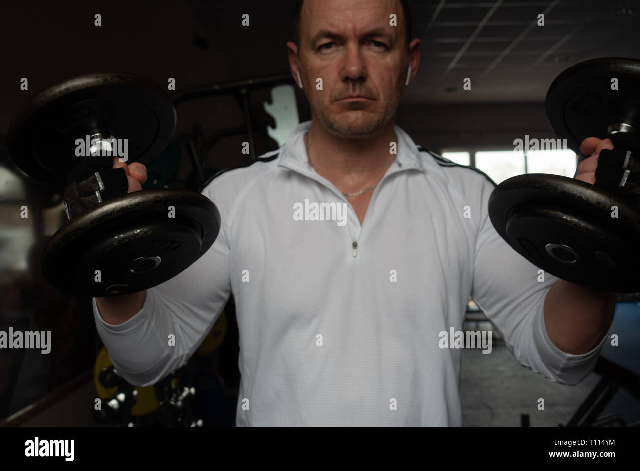 a man with a white shirt trained in sports Stock Photo - Alamy