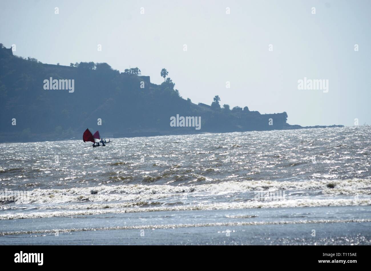 Red Sailing Boat in Arabian sea near fort Stock Photo - Alamy