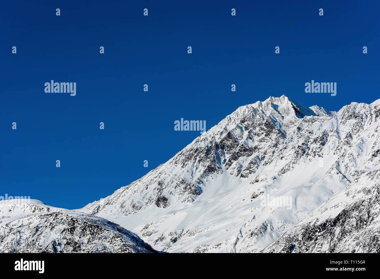 Blue sky and white mountain in Alaska Stock Photo - Alamy