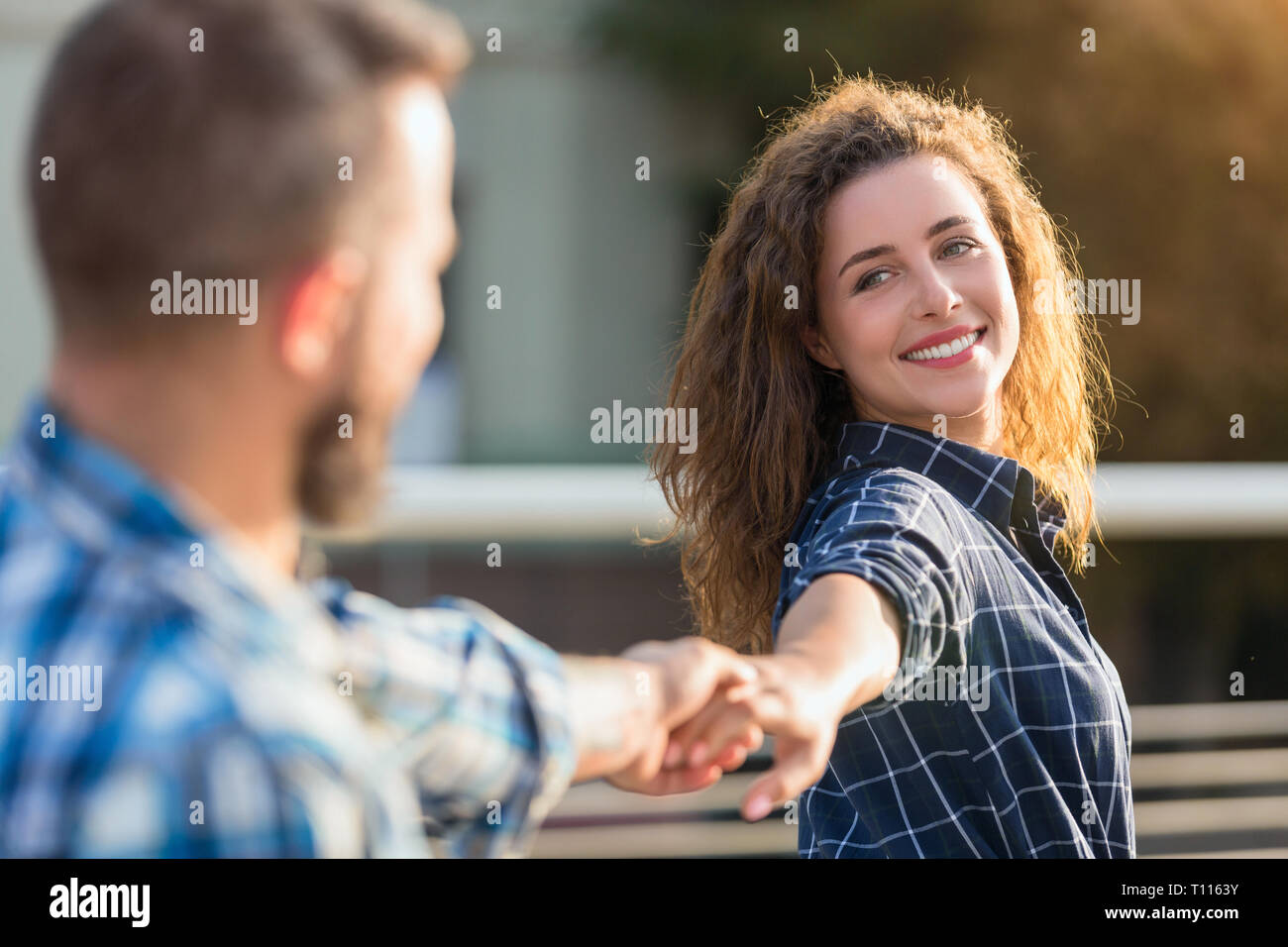 Happy friends holding hands back hi-res stock photography and images ...
